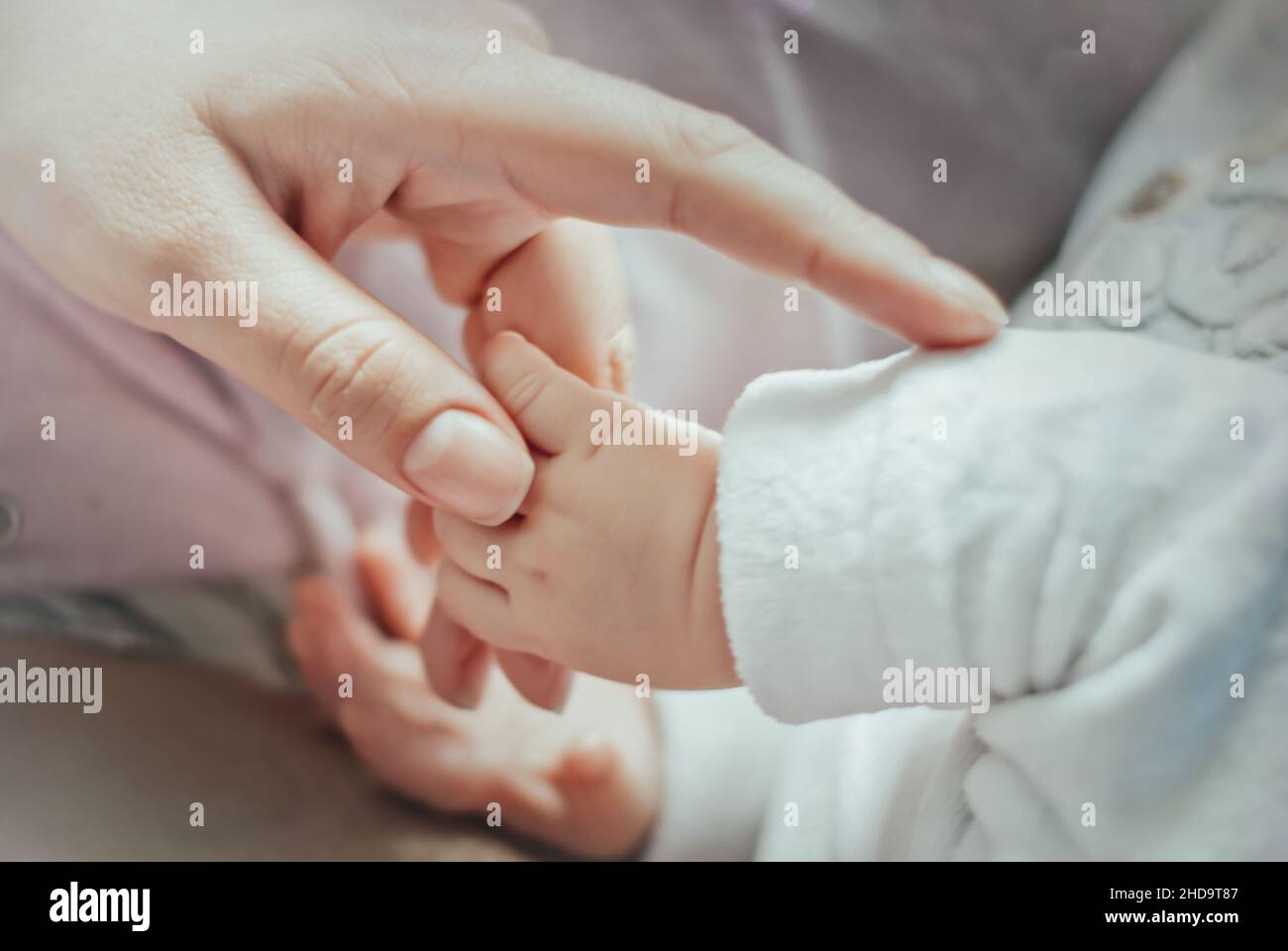 Newborn baby holding mother's hand Stock Photo - Alamy