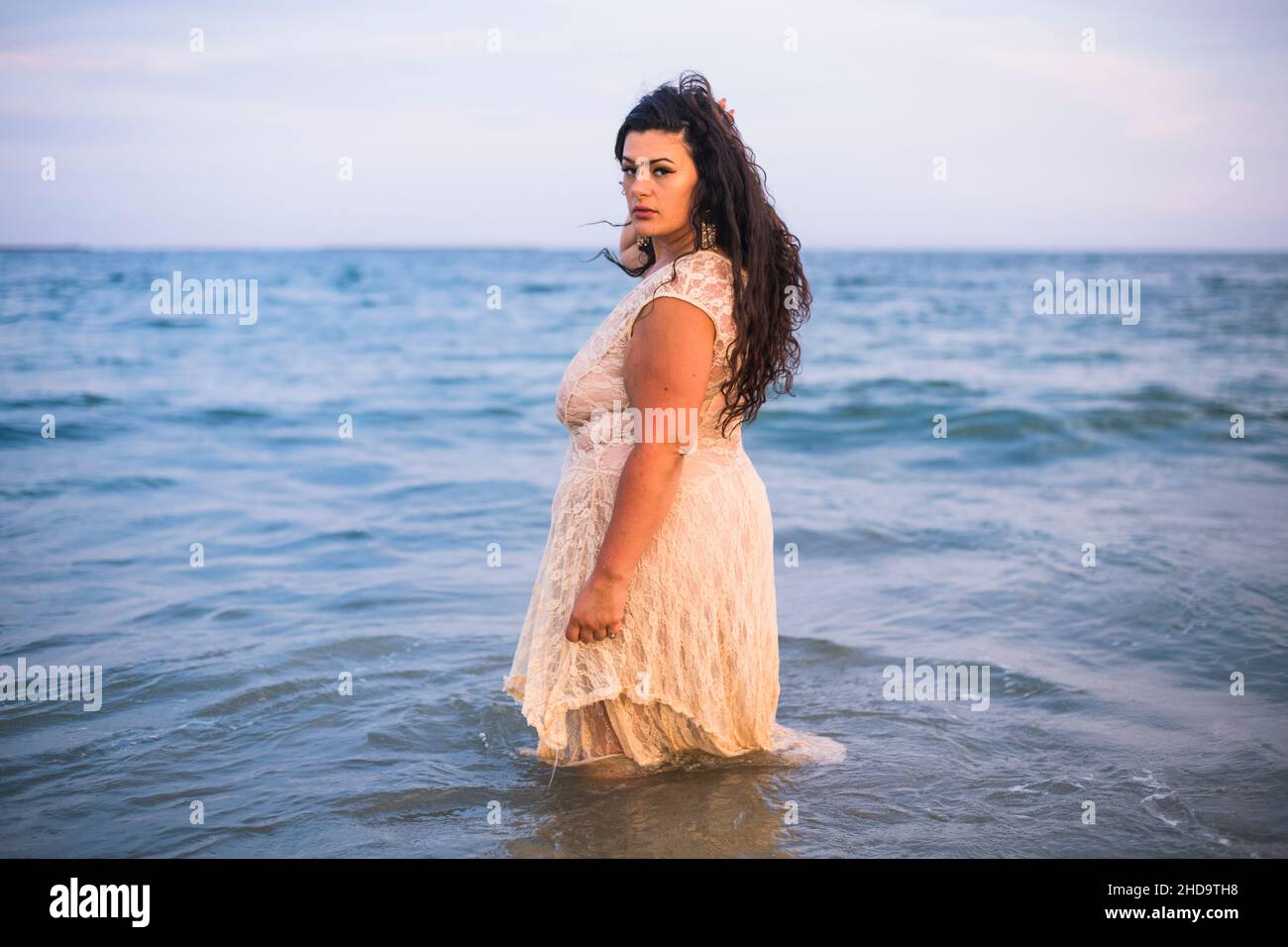 Glam Dusky Portrait of Brunette Woman at beach Stock Photo - Alamy