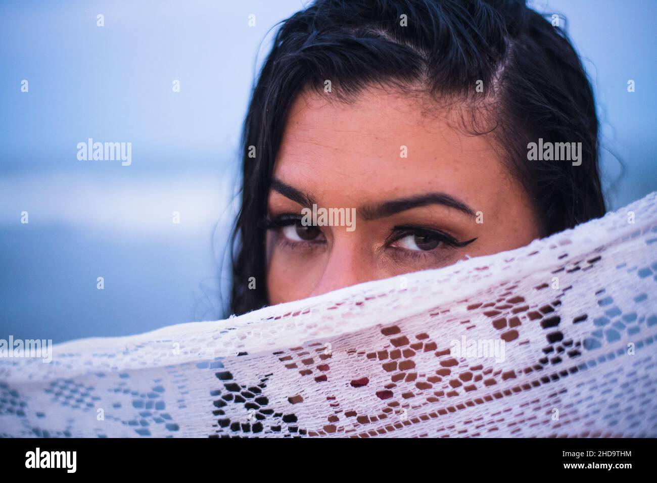 Glam Dusky Portrait of Brunette Woman at beach Stock Photo - Alamy