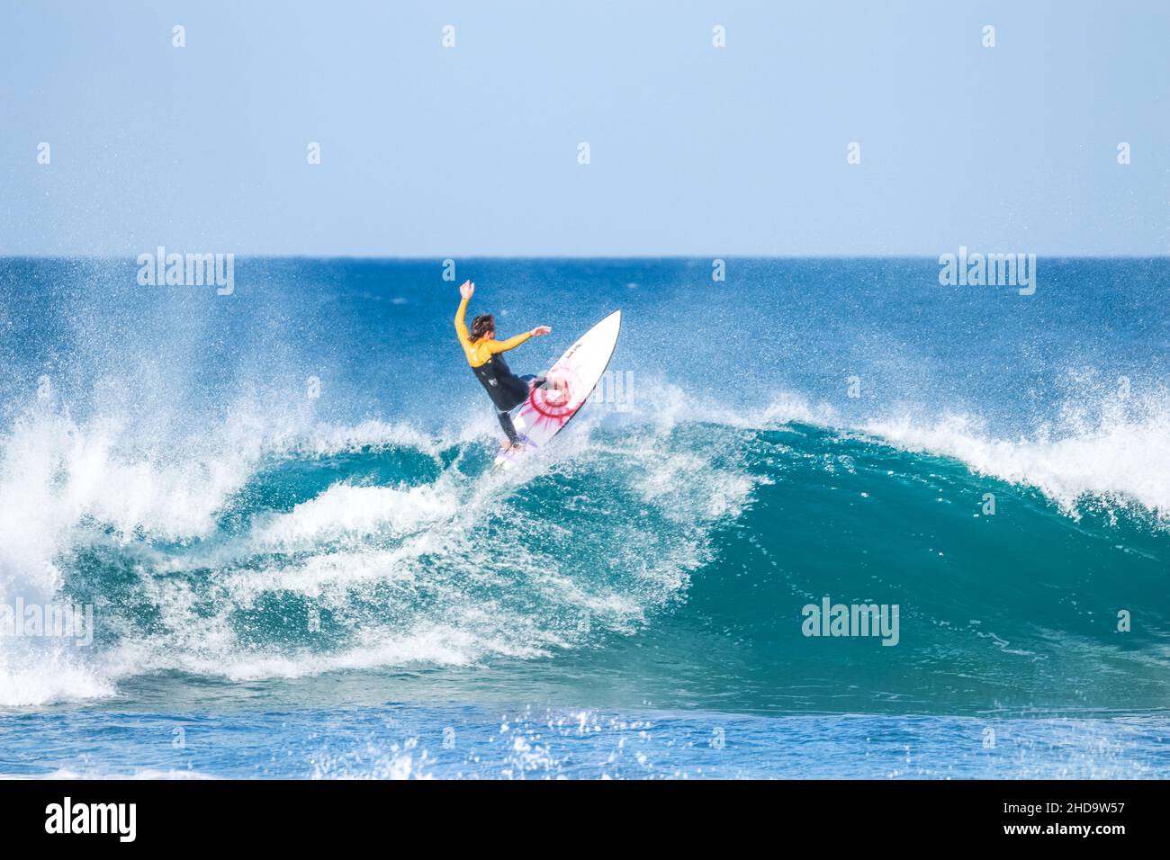 Surfer on a wave in a surf spot Stock Photo - Alamy