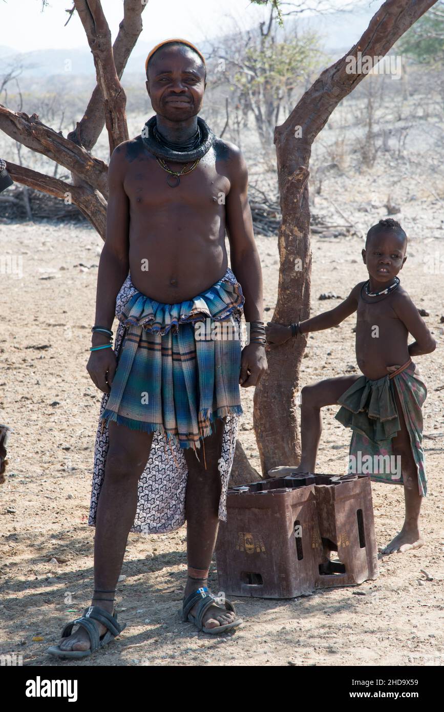 Vertical shot of a African American man and child in Kunene, Namibia ...