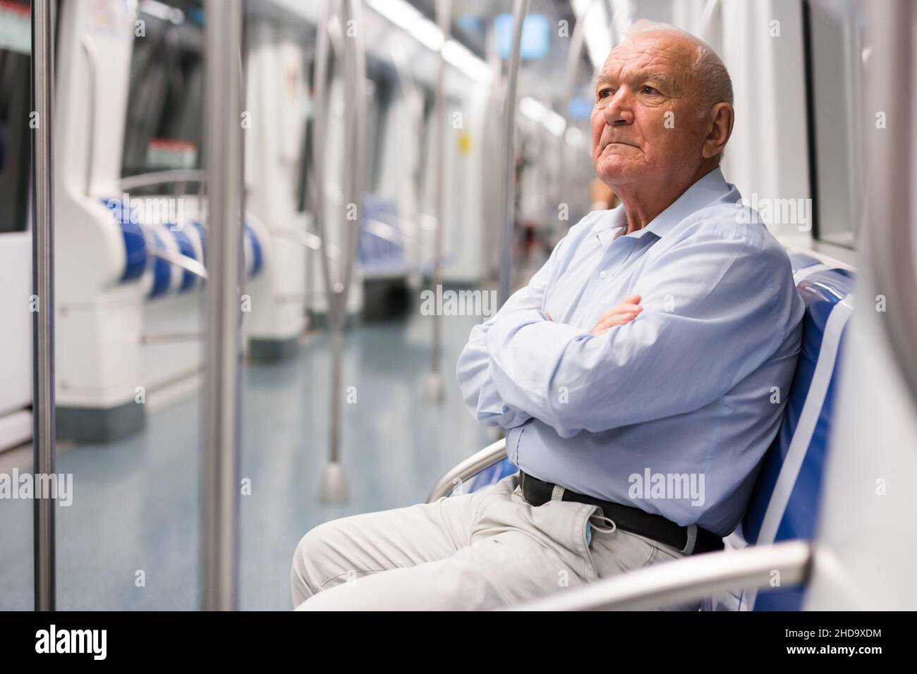 Old man sitting inside subway train Stock Photo - Alamy