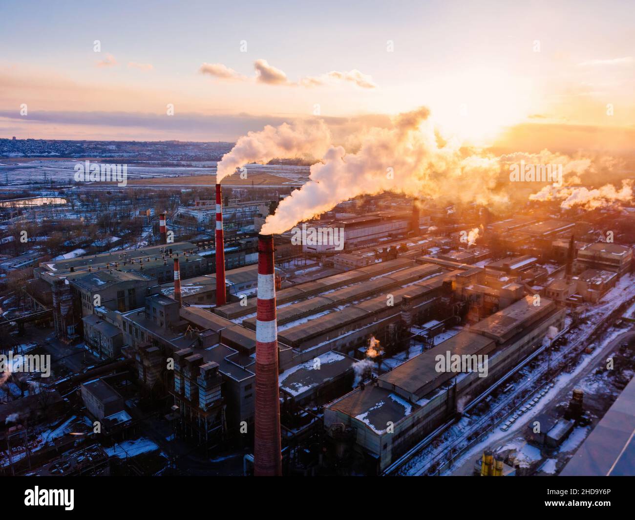 Industrial landscape at the sunset, aerial view. Smoke coming out from ...