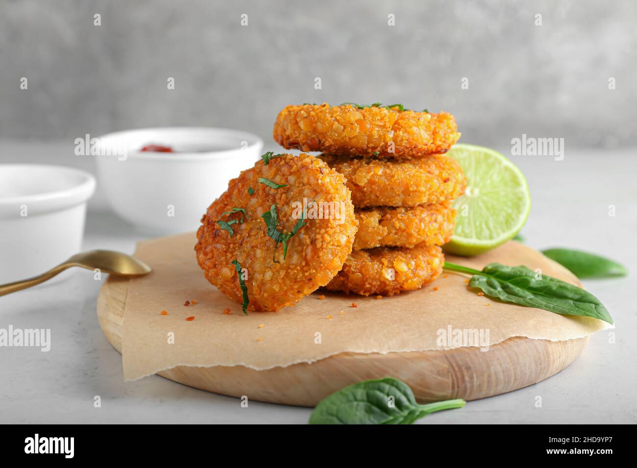 Board with tasty lentil cutlets on grey background Stock Photo - Alamy