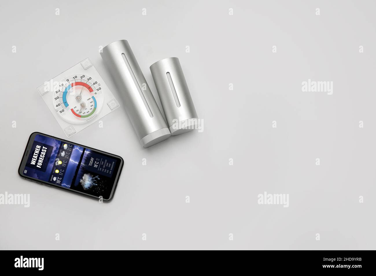 Weather forecast equipment and mobile phone with thermometer on light ...