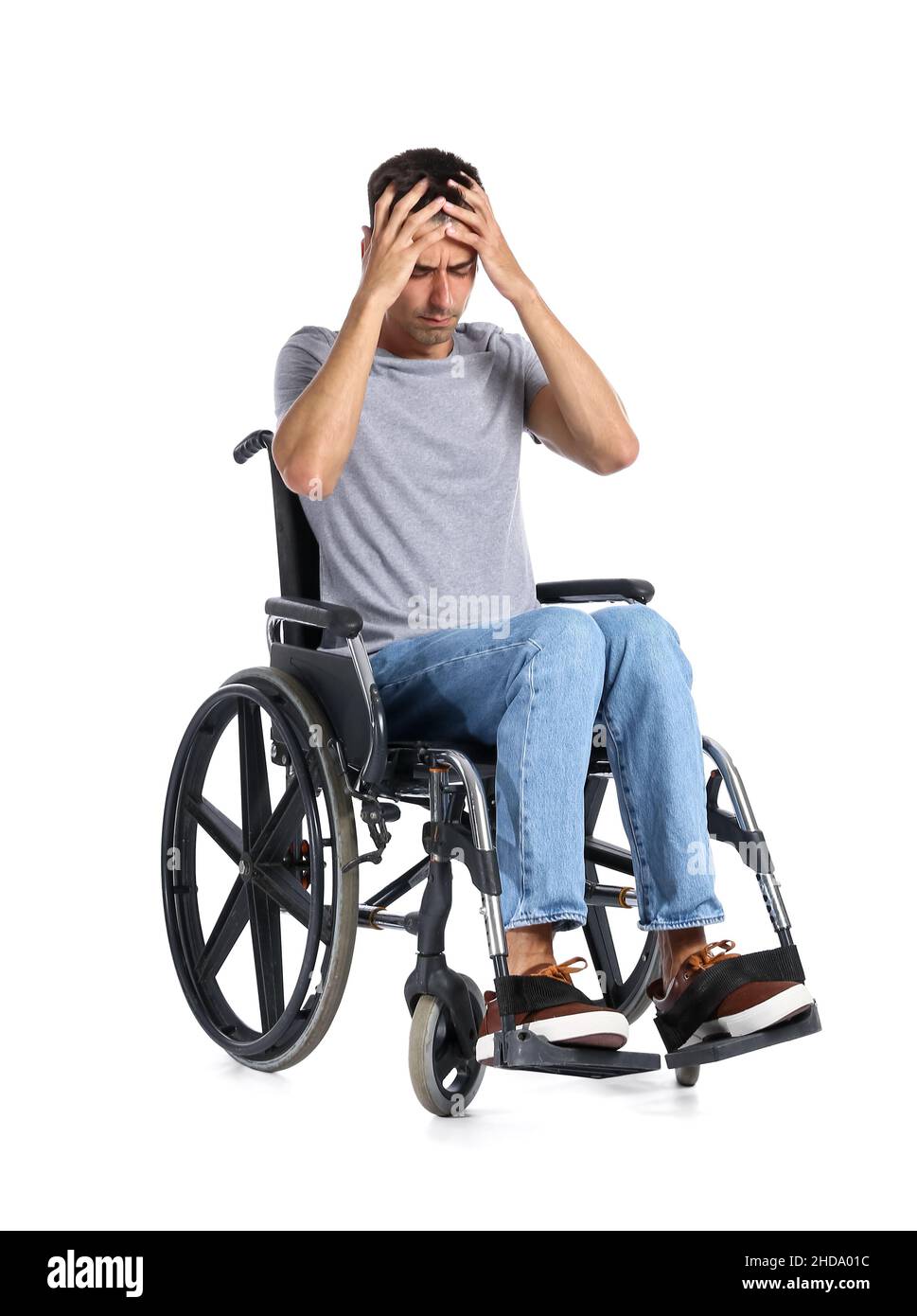 Depressed young man in wheelchair on white background Stock Photo - Alamy