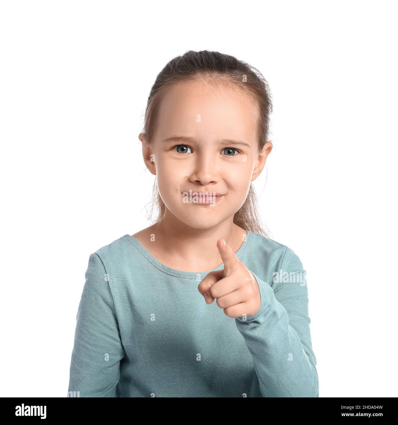 Cute little girl pointing at viewer on white background Stock Photo - Alamy
