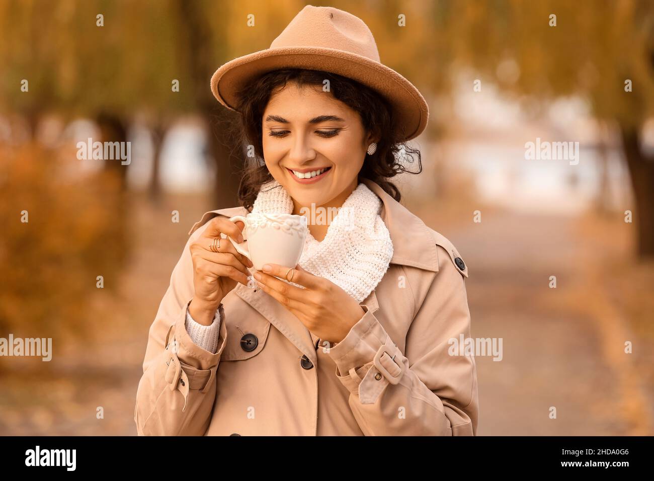 Beautiful woman drinking tea outdoors Stock Photo - Alamy