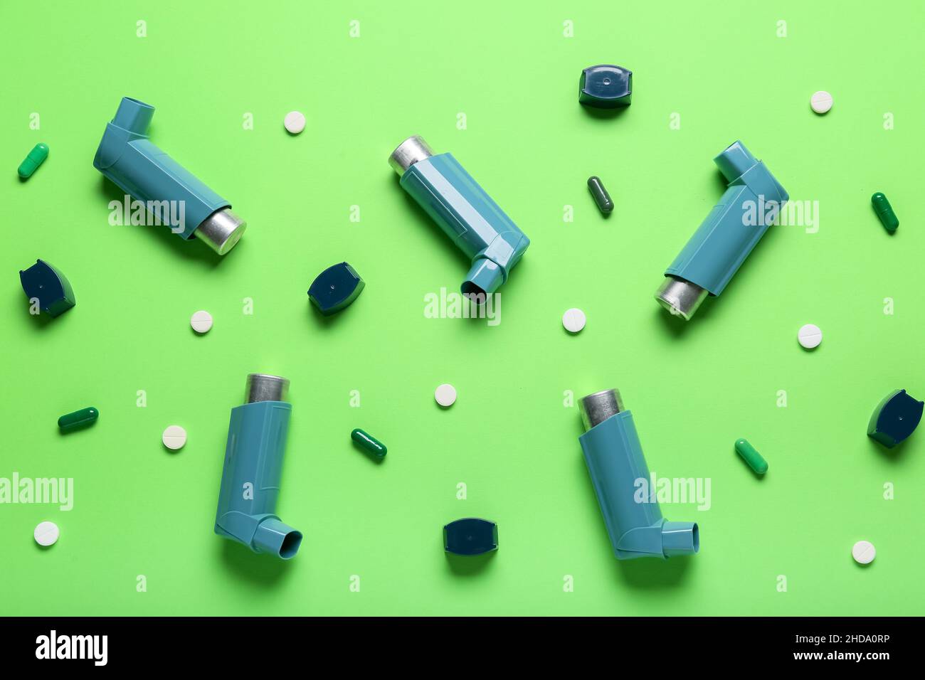 Composition with asthma inhalers and pills on green background Stock ...