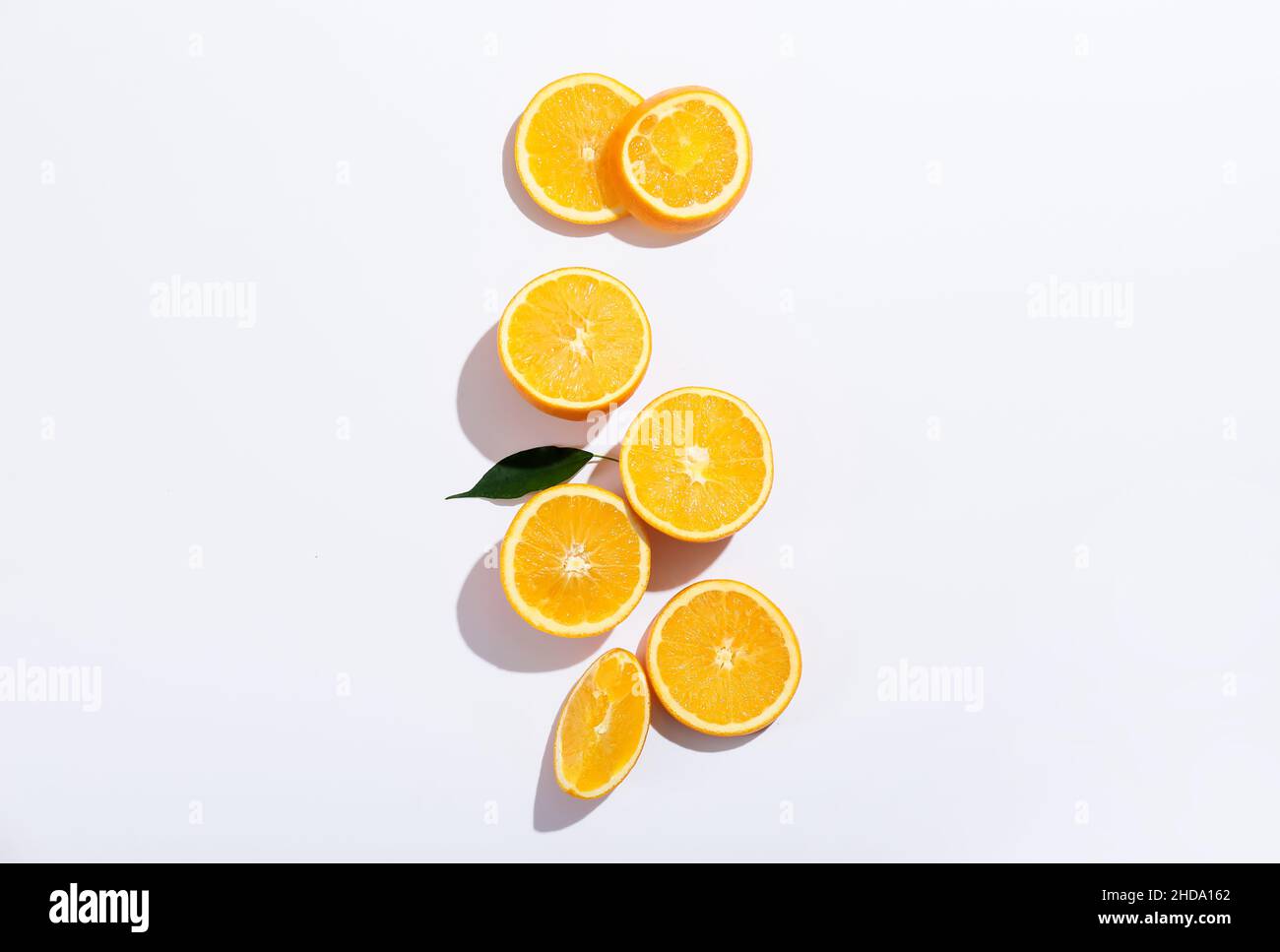 Fresh ripe cut oranges on white background Stock Photo - Alamy