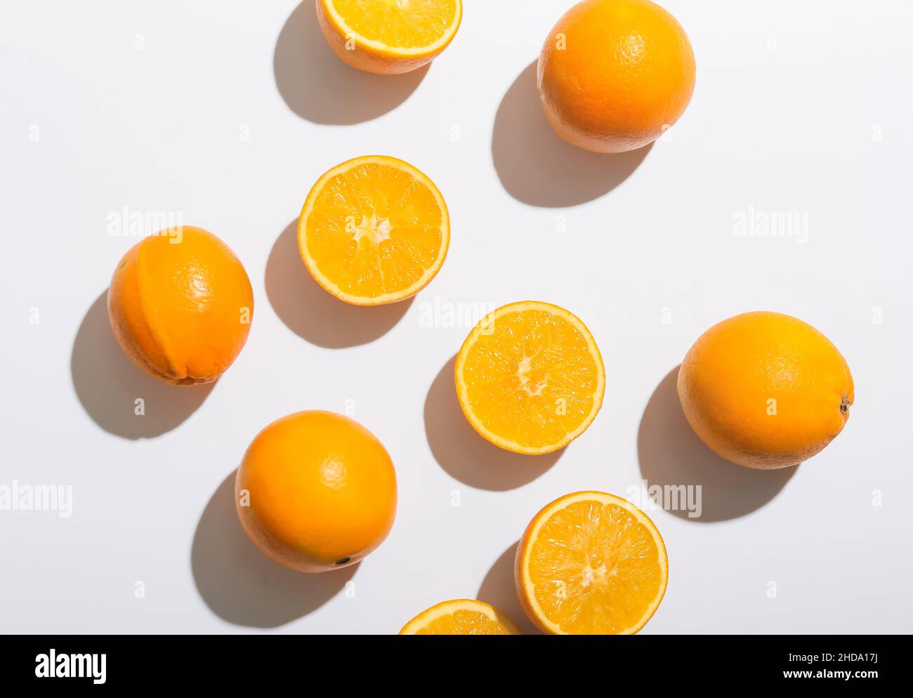 Fresh ripe cut oranges on white background Stock Photo - Alamy