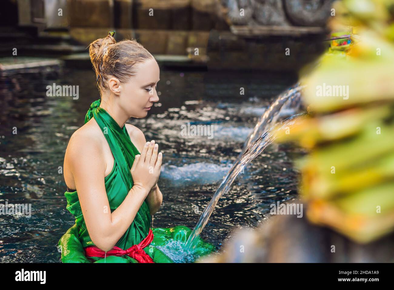 Woman in holy spring water temple in bali. The temple compound consists ...