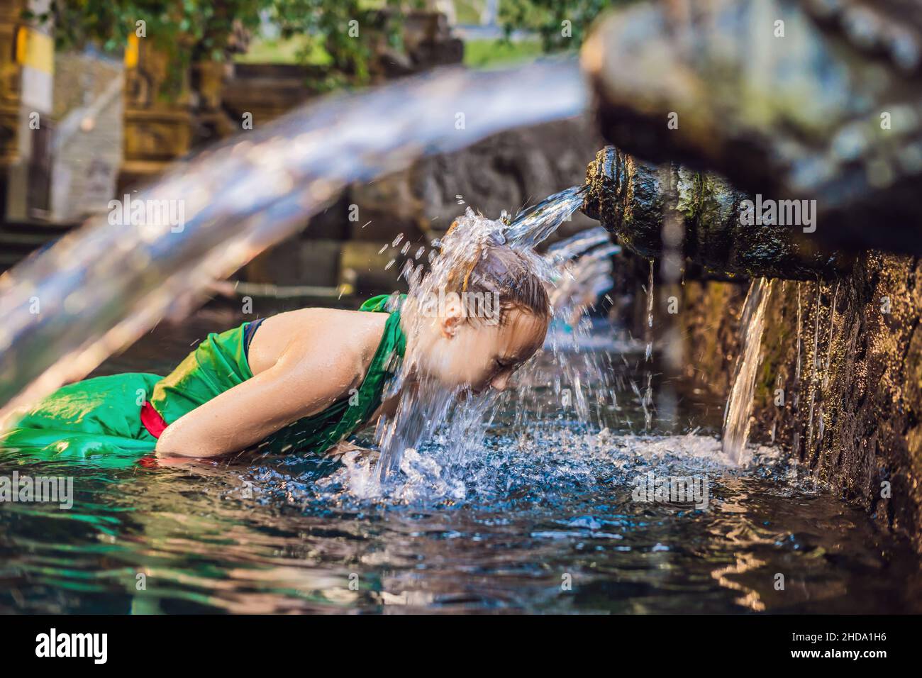 Woman in holy spring water temple in bali. The temple compound consists ...