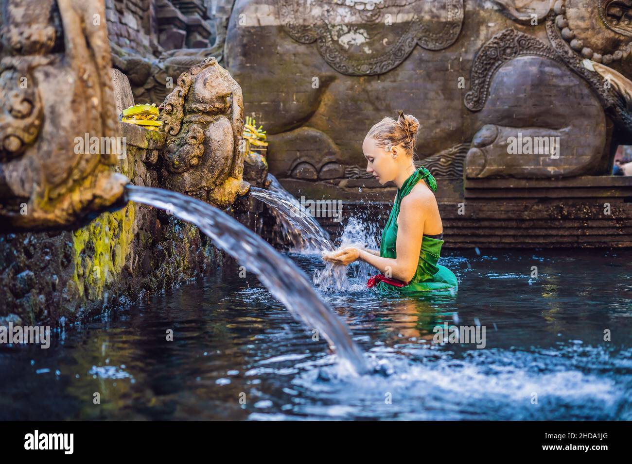 Woman in holy spring water temple in bali. The temple compound consists ...