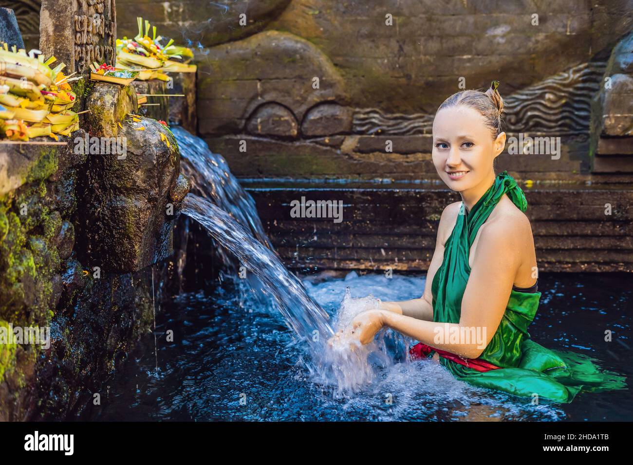 Woman in holy spring water temple in bali. The temple compound consists ...