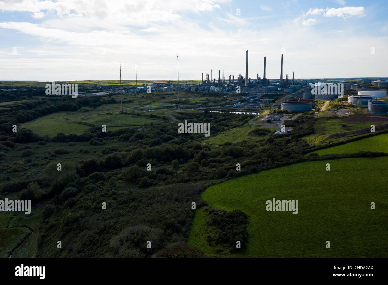 Aerial shot of an oil refinery industrial site with a forest around the ...
