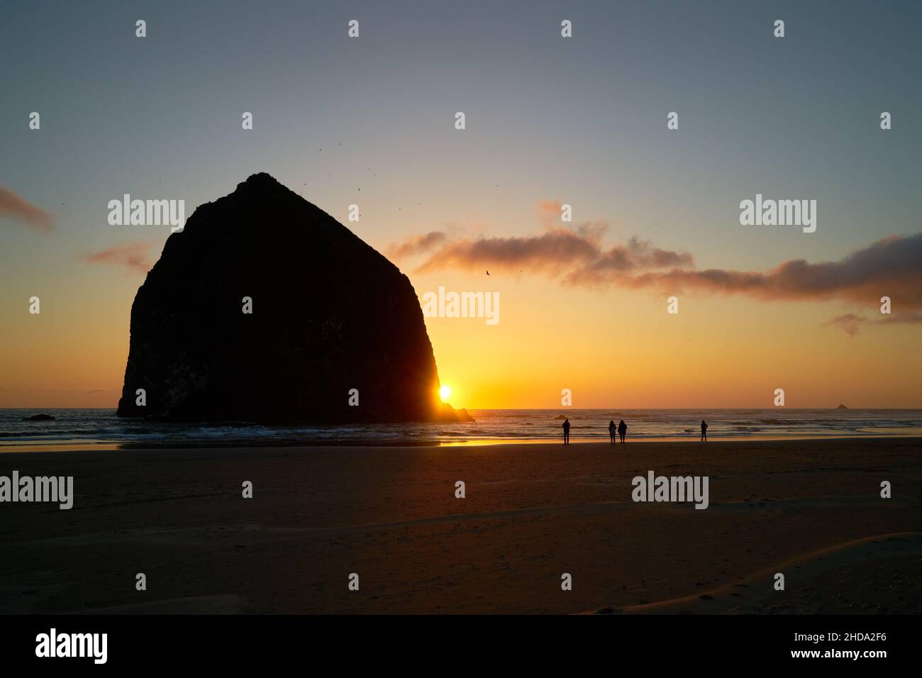 Sunset behind Haystack Rock Cannon Beach. Sunset at Haystack Rock in ...