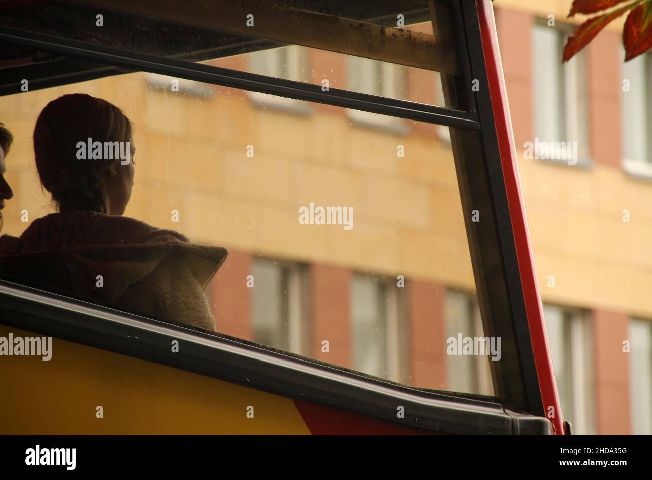 Closeup shot of passengers on a public bus sitting near the window in ...