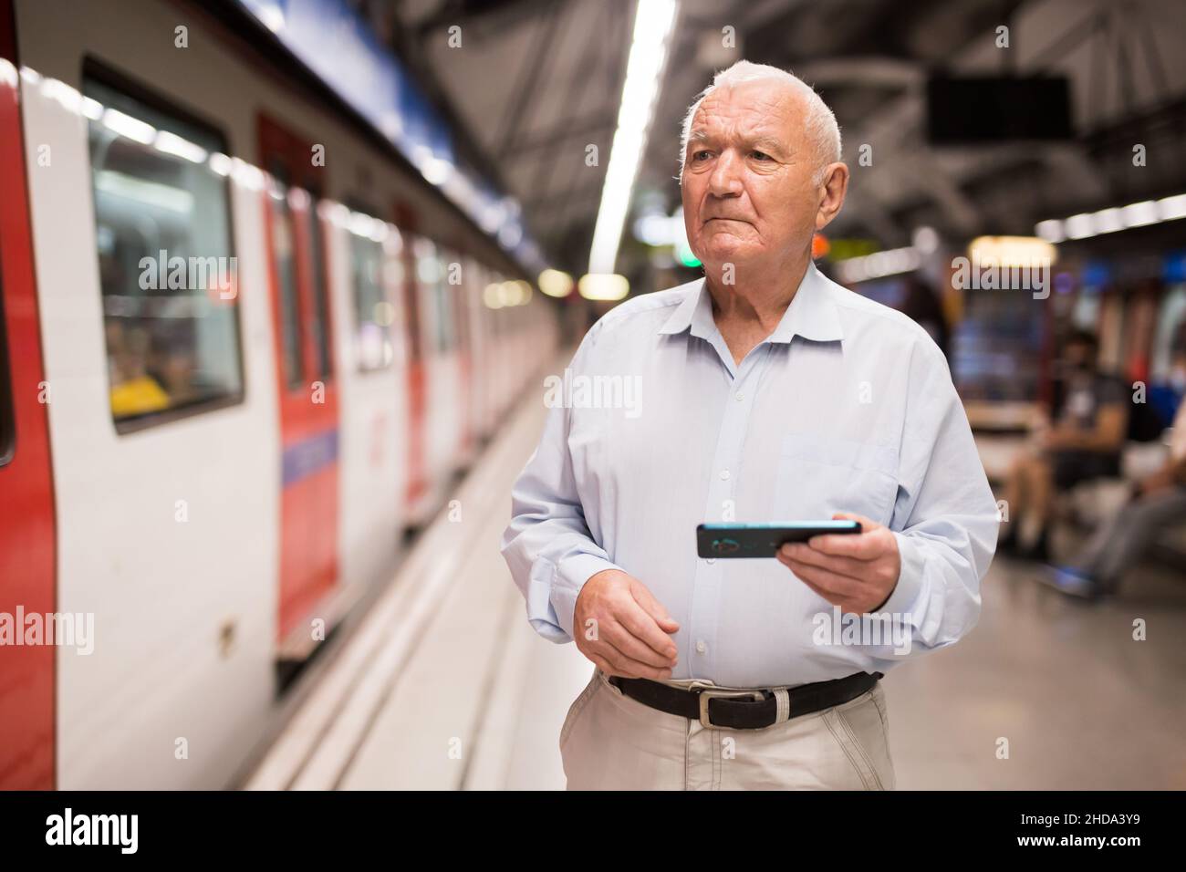 Elderly man in metro station Stock Photo - Alamy