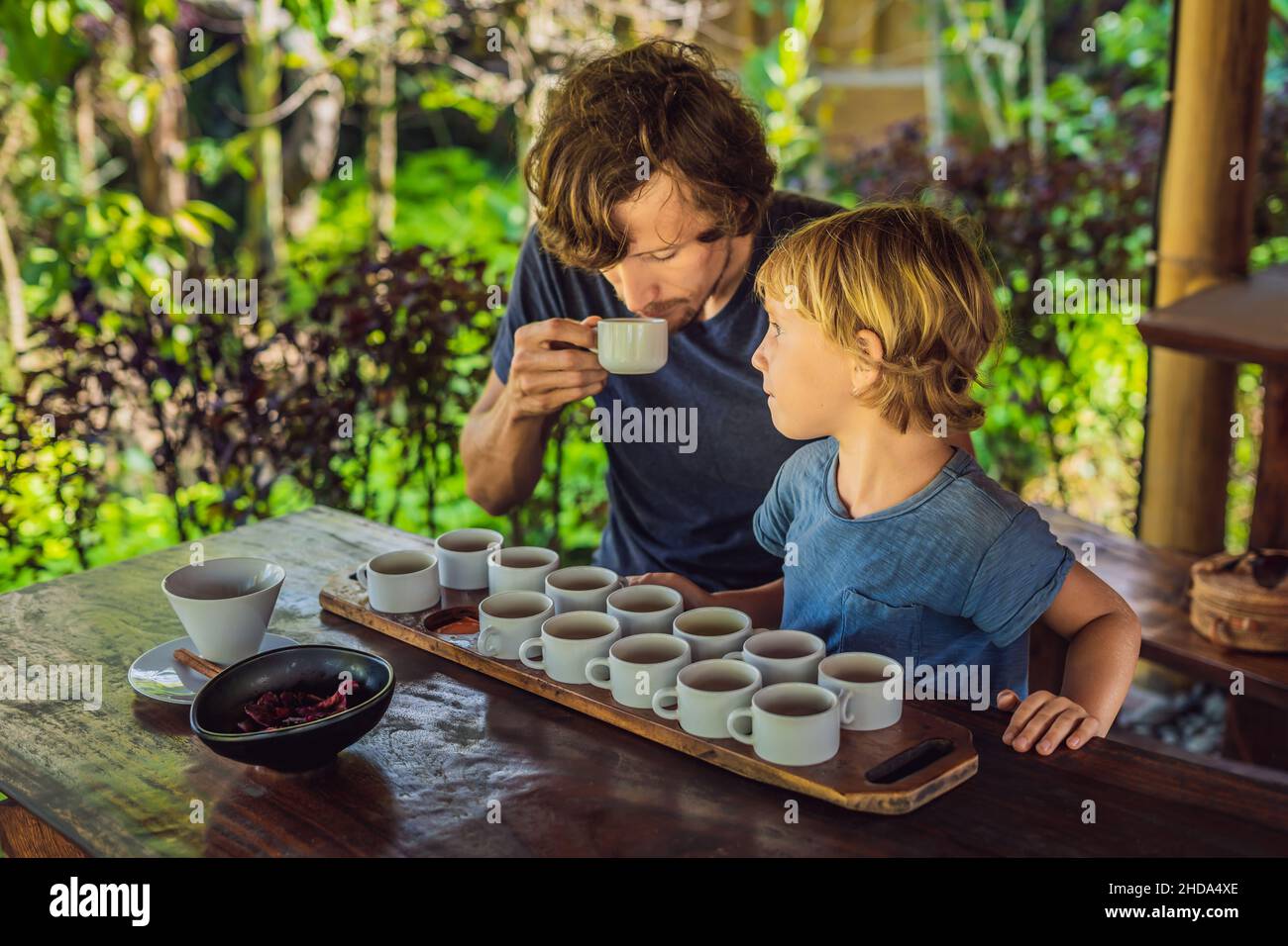 Dad and son are tasting different kinds of coffee and tea, including ...
