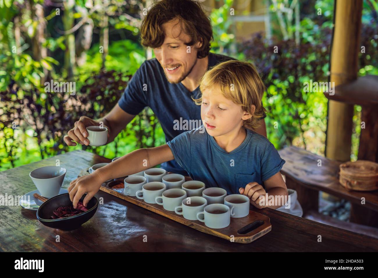 Dad and son are tasting different kinds of coffee and tea, including ...