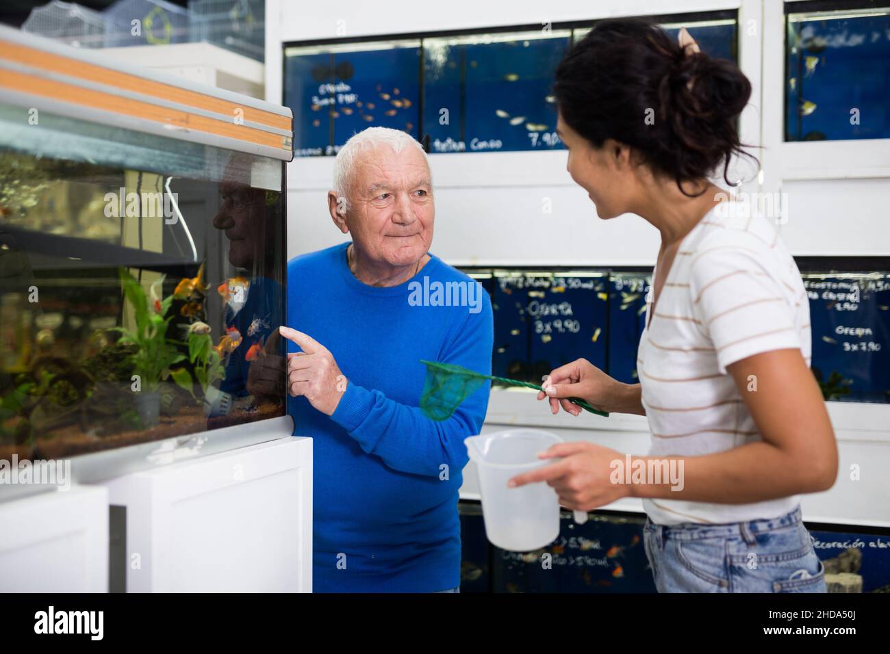 Old woman buying fish hi-res stock photography and images - Alamy