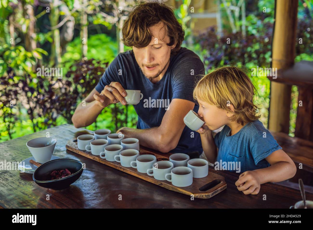 Dad and son are tasting different kinds of coffee and tea, including ...
