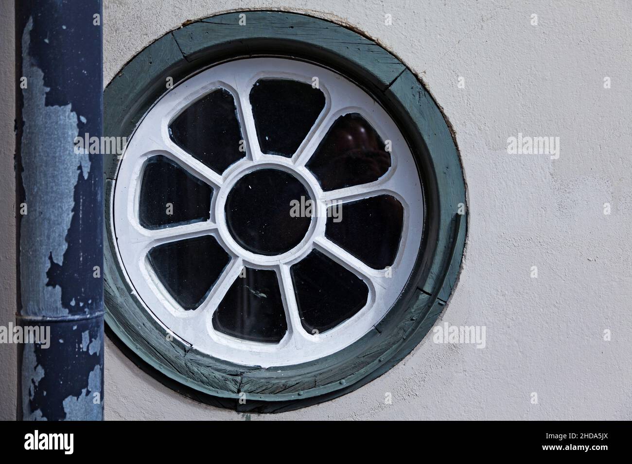 an old round window with white spokes Stock Photo - Alamy