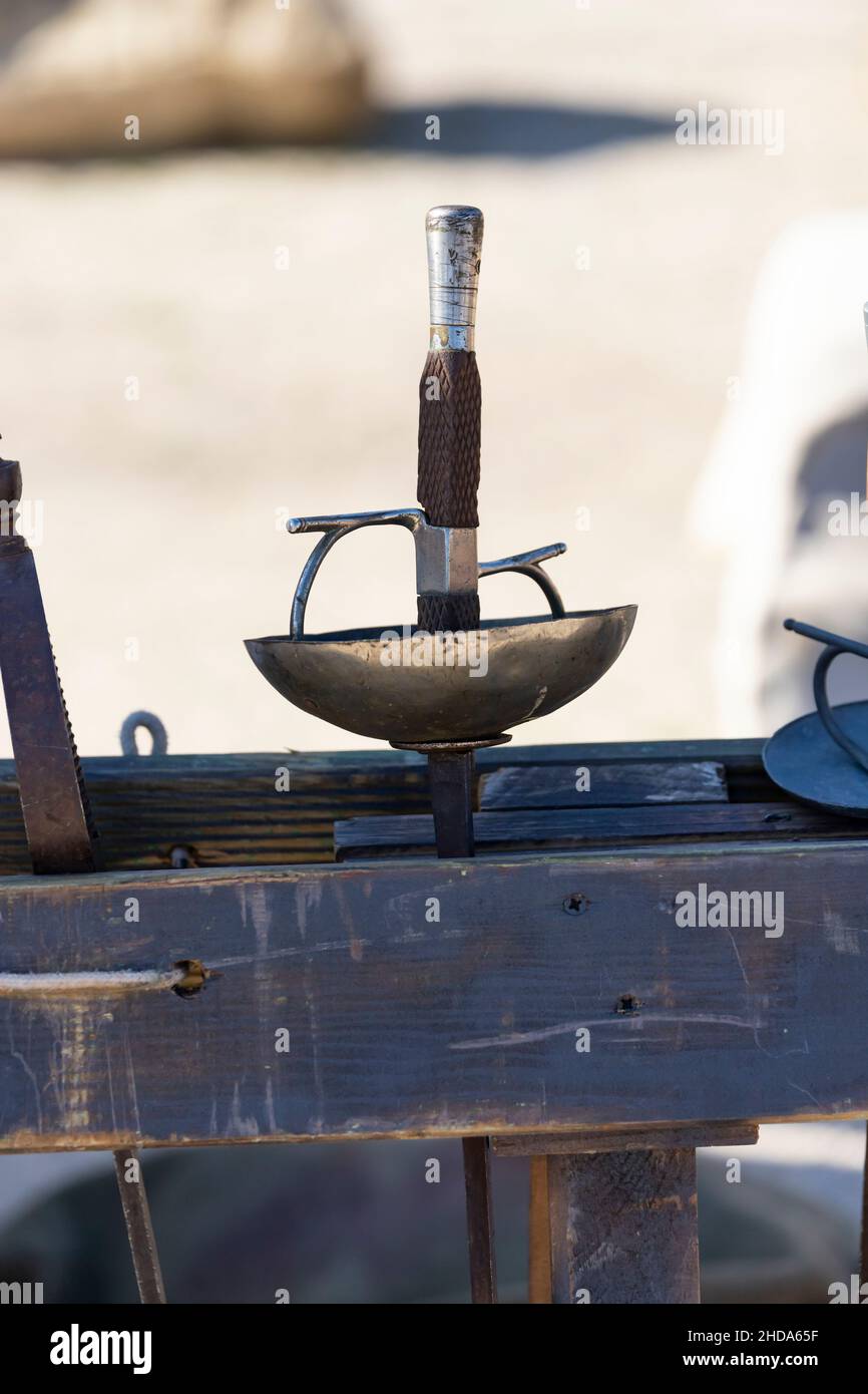 foreground in vertical view of hilt of a cup rapier sword from the 16th ...