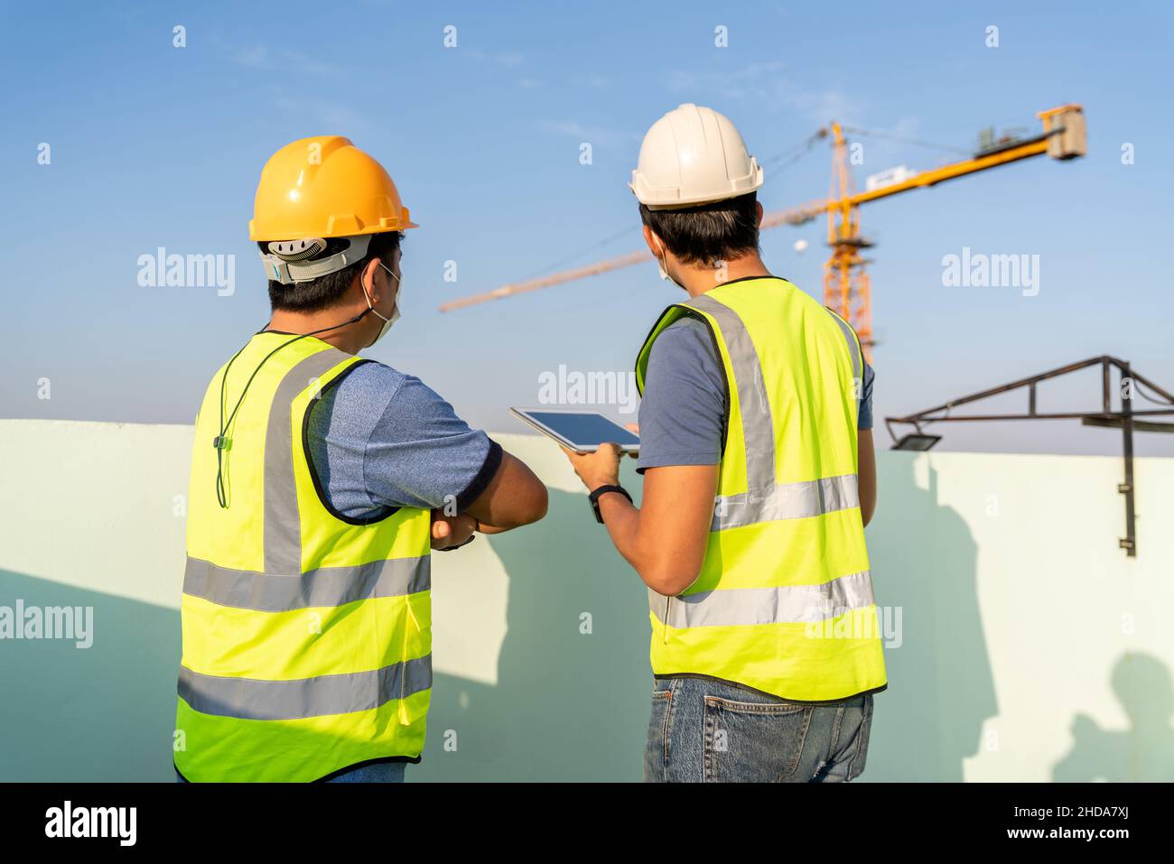 Engineer and foreman inspect the crane on the construction site Stock ...
