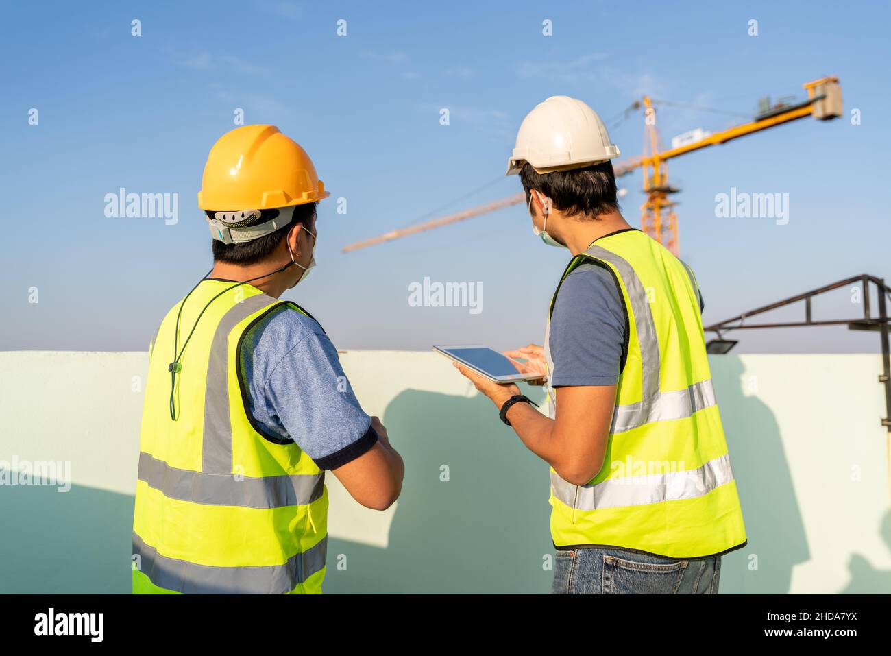 Engineer use a tablet introducing the foreman to inspect and supervise ...