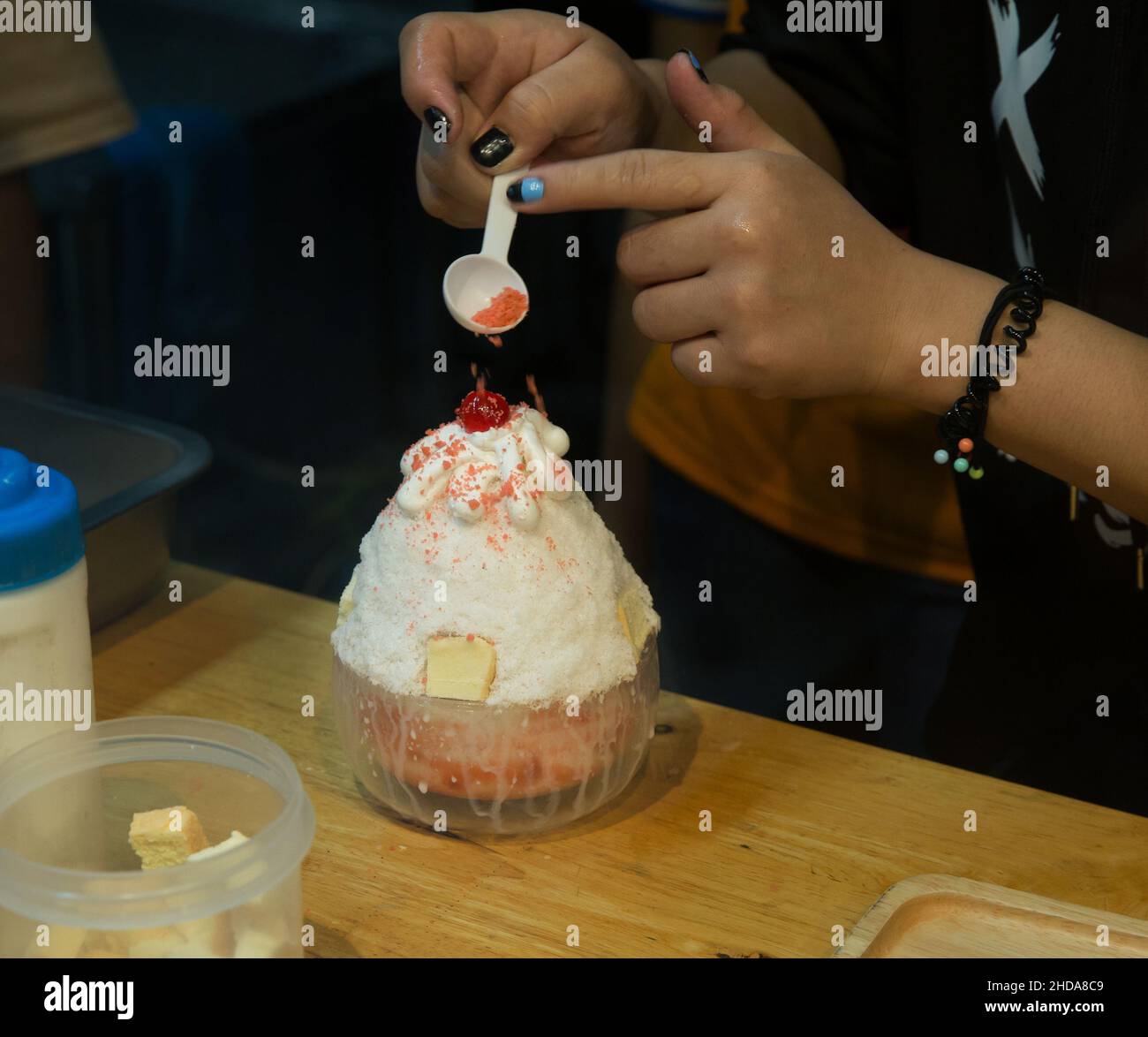 Top view of Bingsu or Korean shaved ice dessert with cherry whipped ...