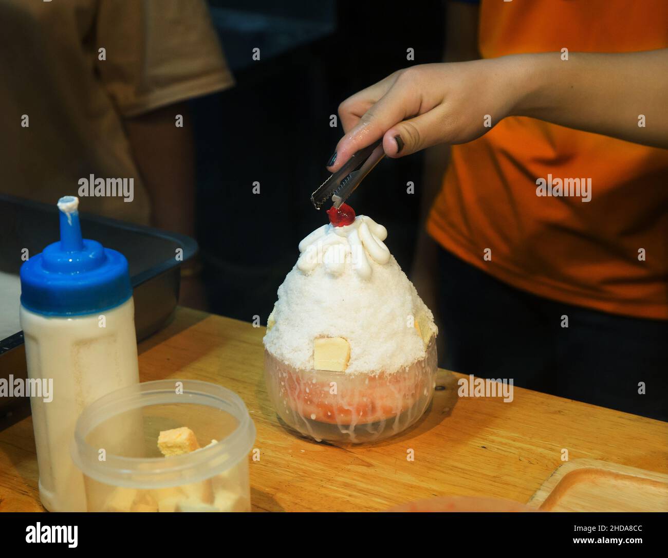 Top view of Bingsu or Korean shaved ice dessert with cherry whipped ...