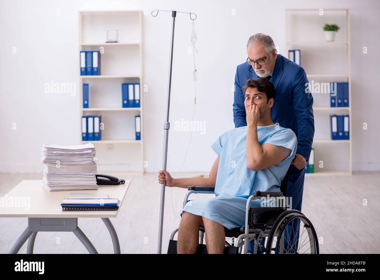 Young employee in wheel-chair feeling bad at workplace Stock Photo - Alamy