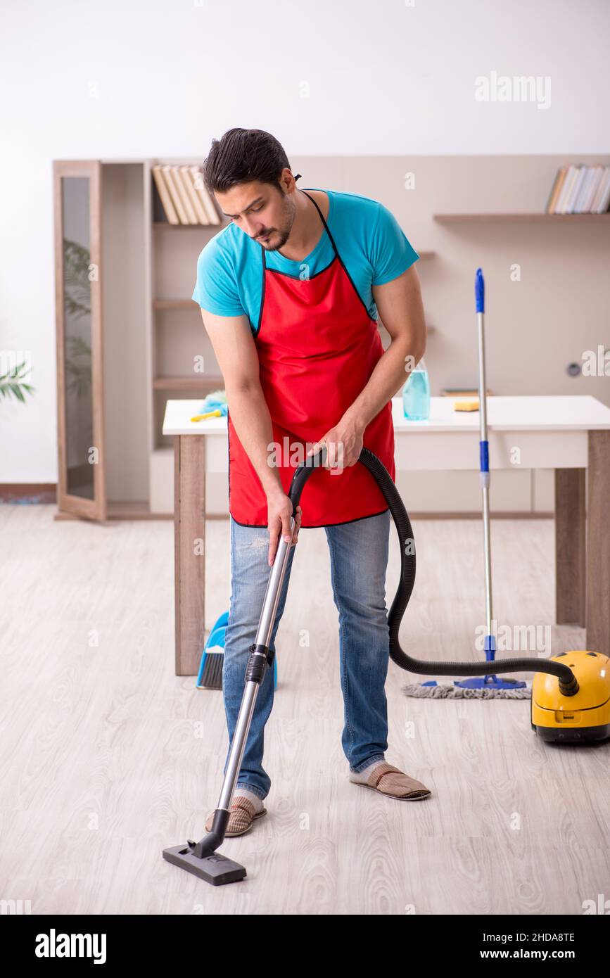 Young contractor cleaning the house Stock Photo - Alamy