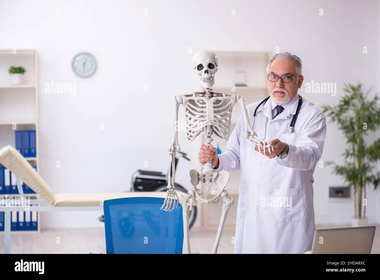 Old doctor demonstrating human skeleton Stock Photo - Alamy