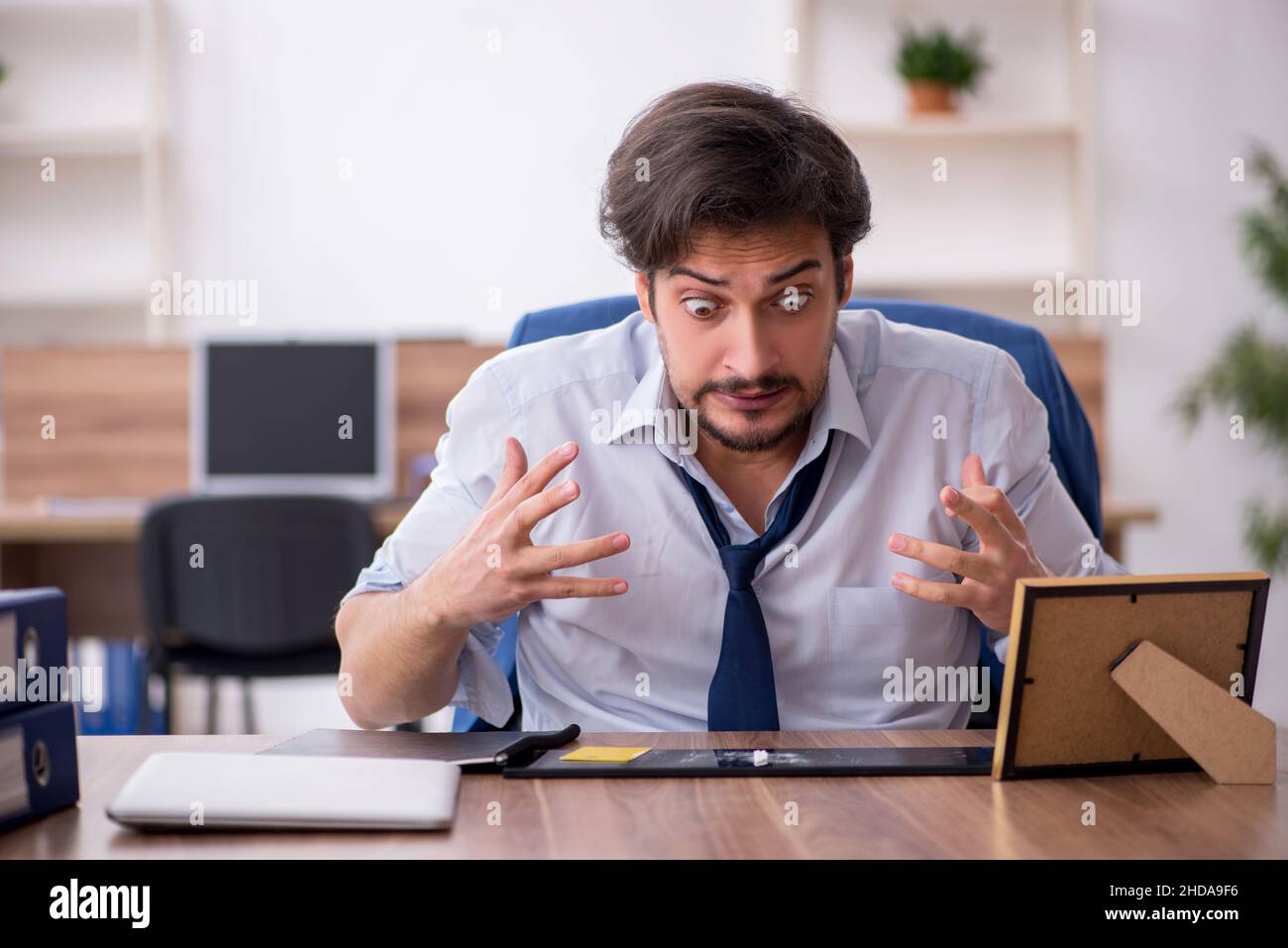 Young male drug addicted employee in the office Stock Photo - Alamy
