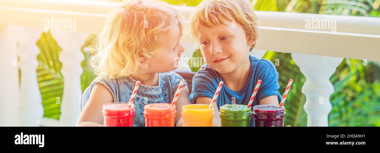 Children drink colorful healthy smoothies.. Watermelon, papaya, mango ...