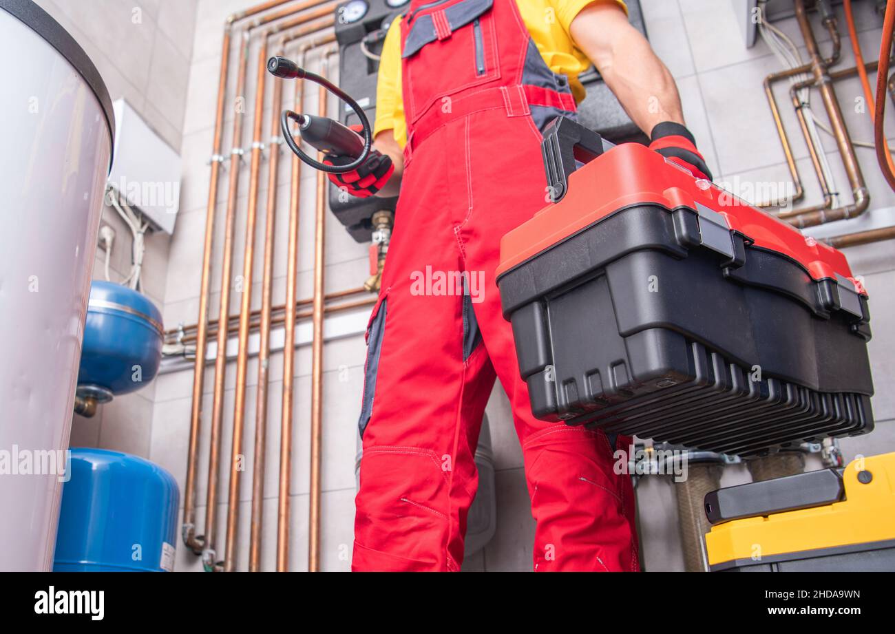 Residential Furnace System Technician at Work. Check and Repair HVAC ...