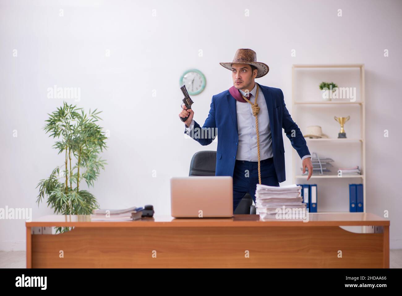Young cowboy employee working at workplace Stock Photo - Alamy