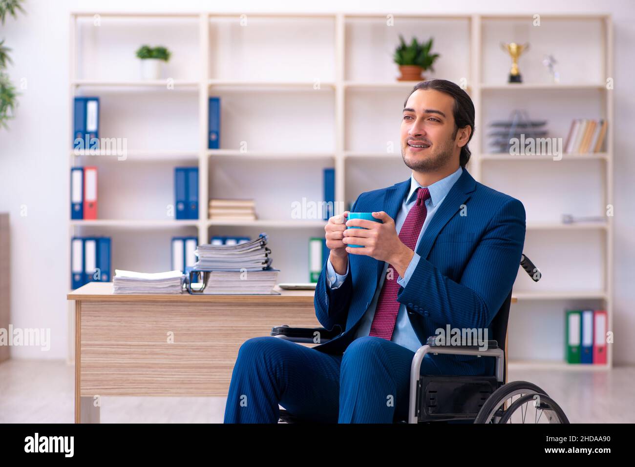 Young male disabled employee working in the office Stock Photo - Alamy
