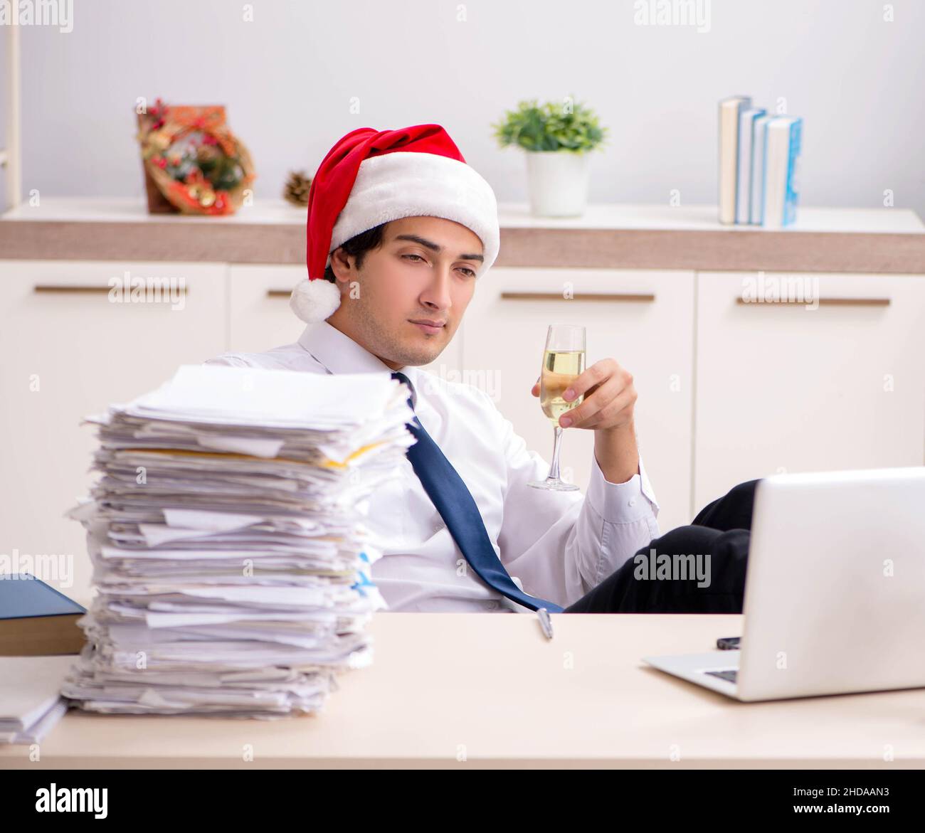The young worker working in office on christmas shift Stock Photo - Alamy