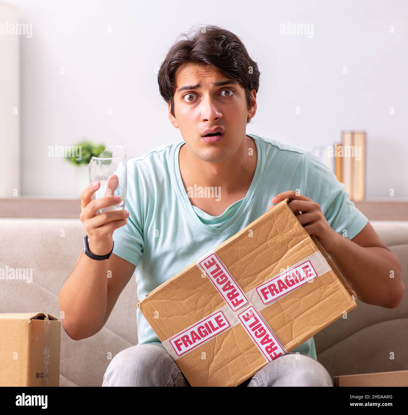 The man opening fragile parcel ordered from internet Stock Photo - Alamy
