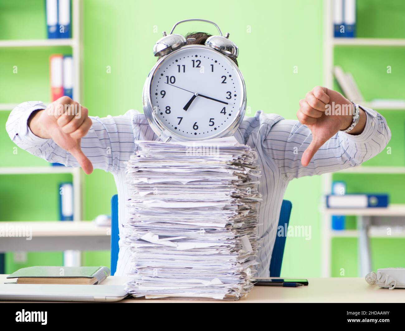 The businessman having problems with paperwork and workload Stock Photo ...