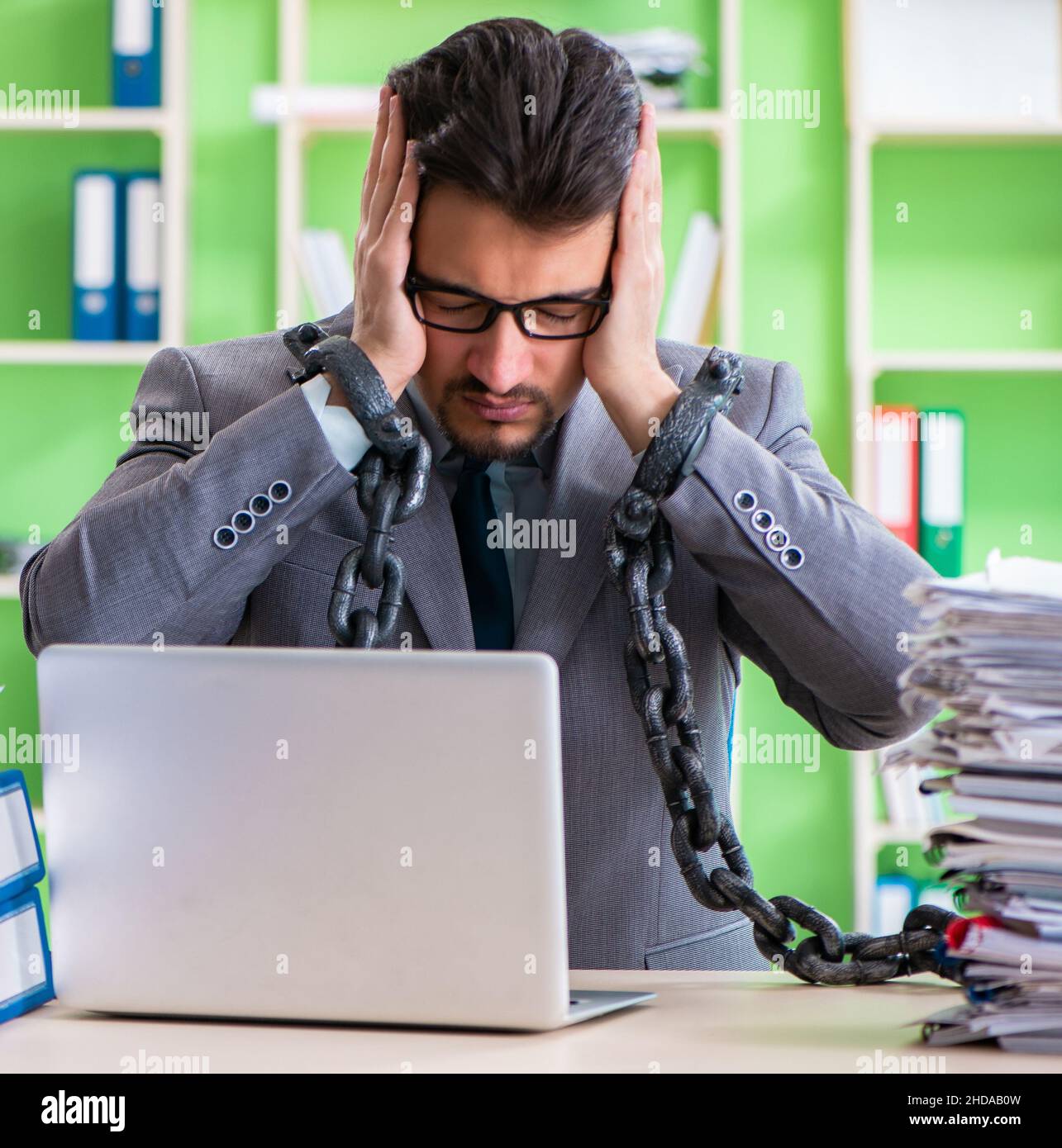 Man chained to desk hi-res stock photography and images - Alamy