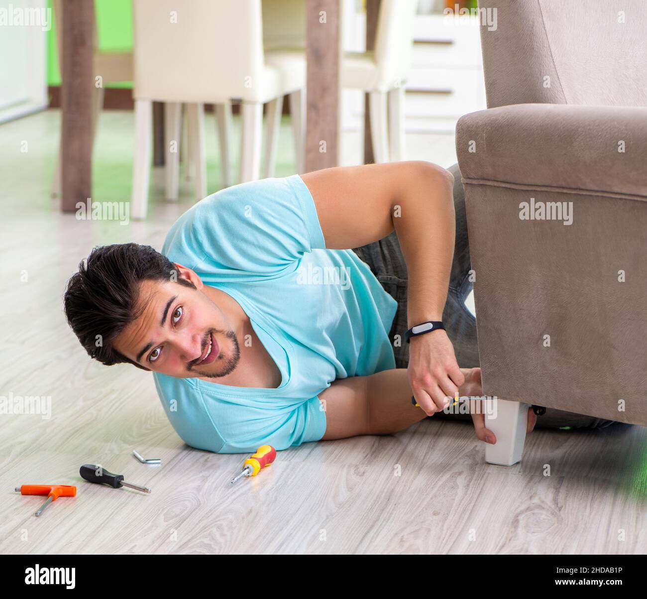 The man repairing furniture at home Stock Photo - Alamy