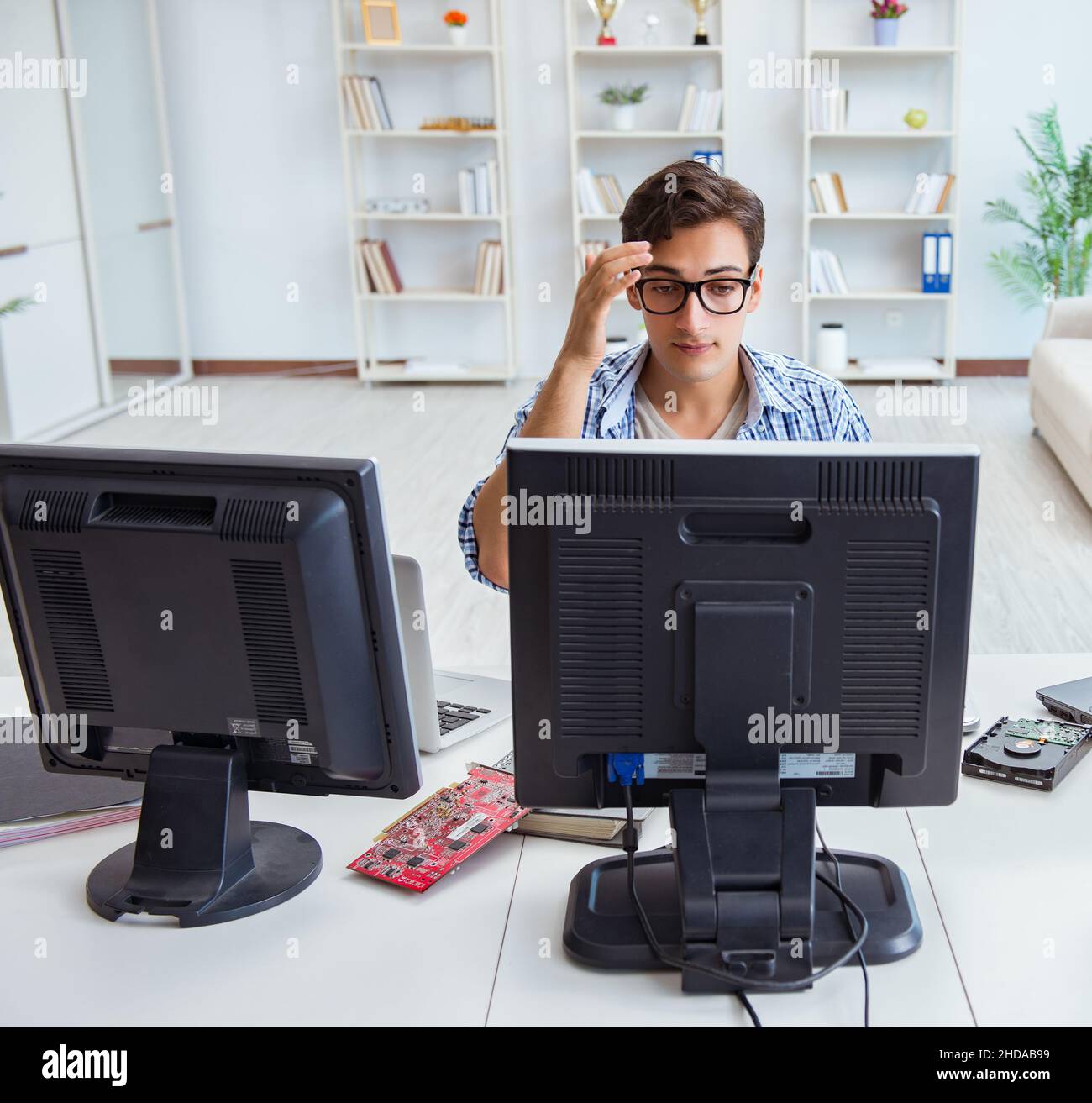The young trader monitoring markets on screens Stock Photo - Alamy