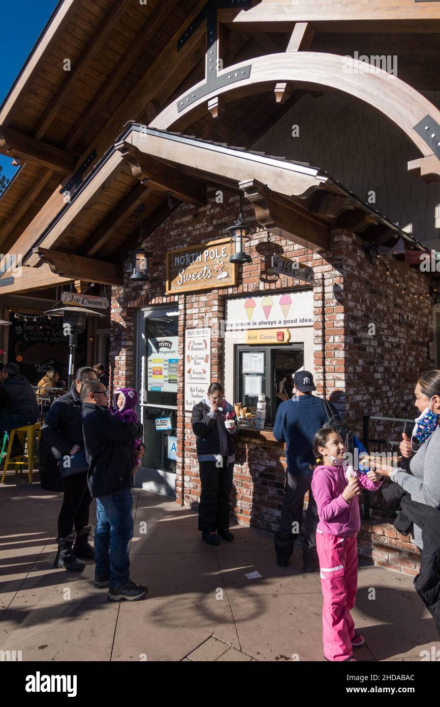 People standing at the front of the North Pole Sweets ice cream store ...