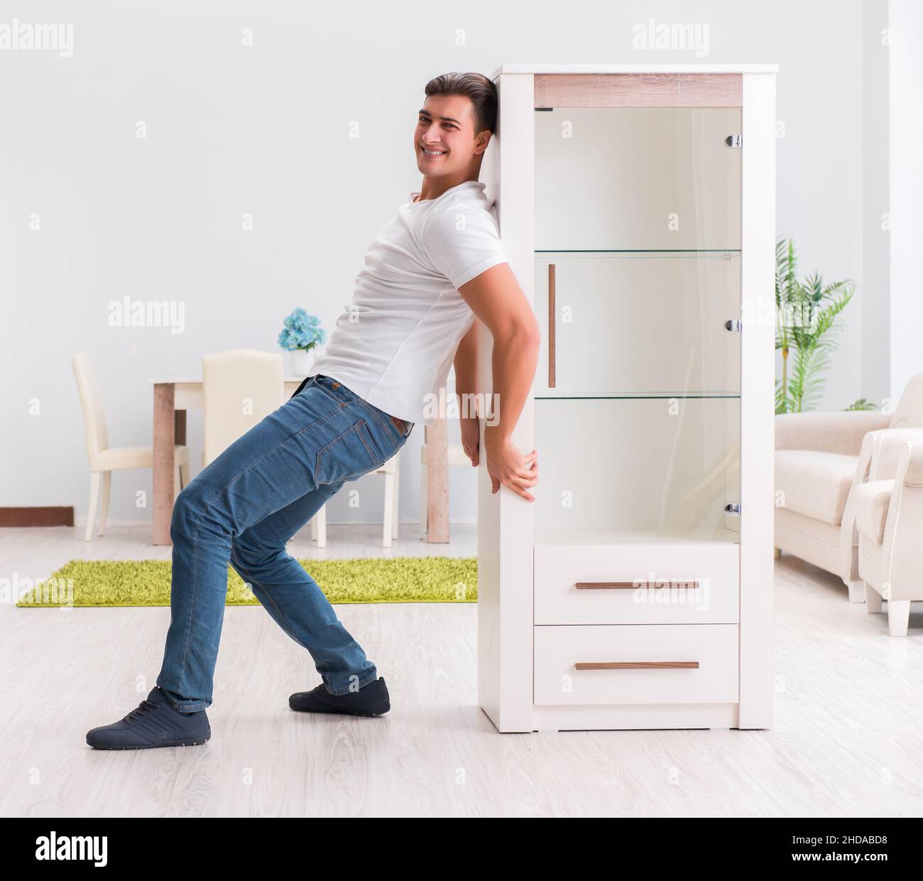 The man moving furniture at home Stock Photo - Alamy