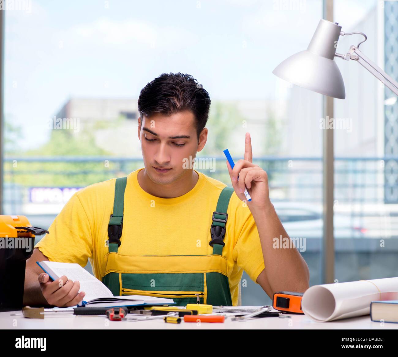 The construction worker sitting at the desk Stock Photo - Alamy